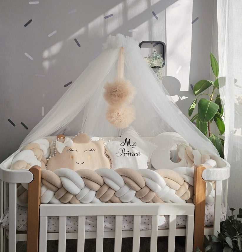 Beige baby crib bedding set with braided crib bumper